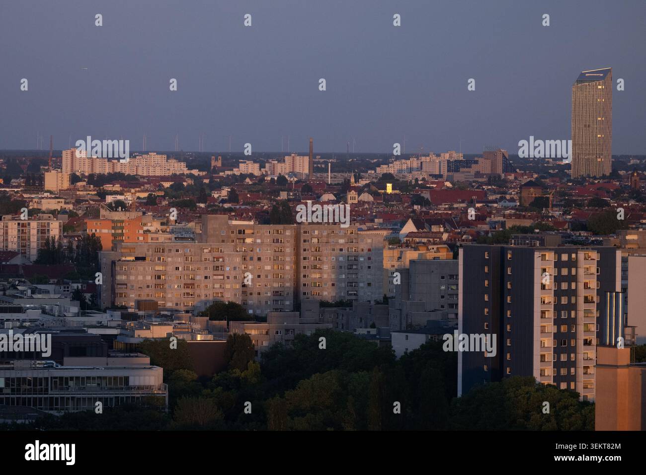 03 June 2026, Berlin: The light of the setting sun falls on apartment ...