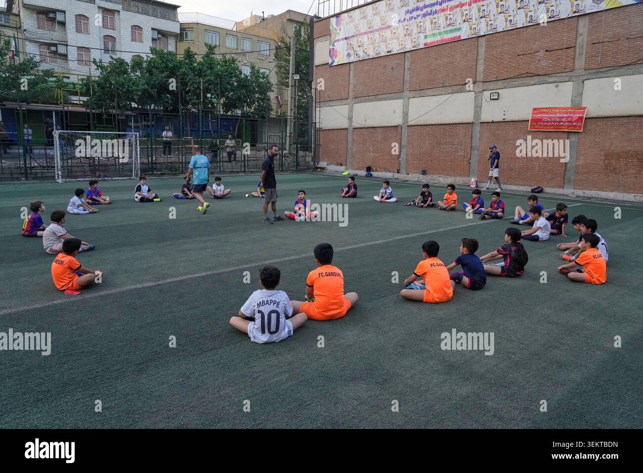 Children listen to their coaches during a soccer training session. in ...
