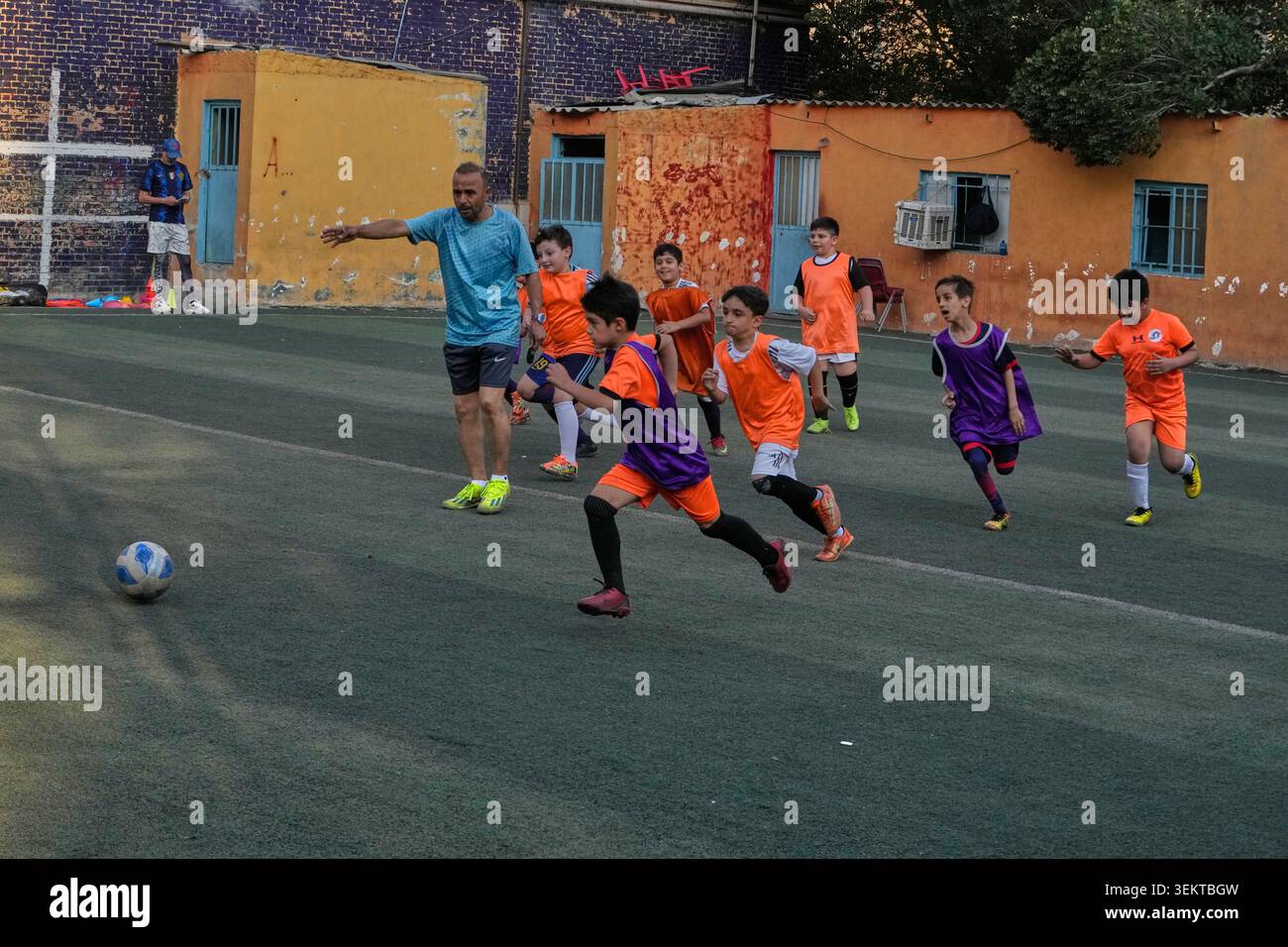 Children play under their coach supervision during a soccer training ...