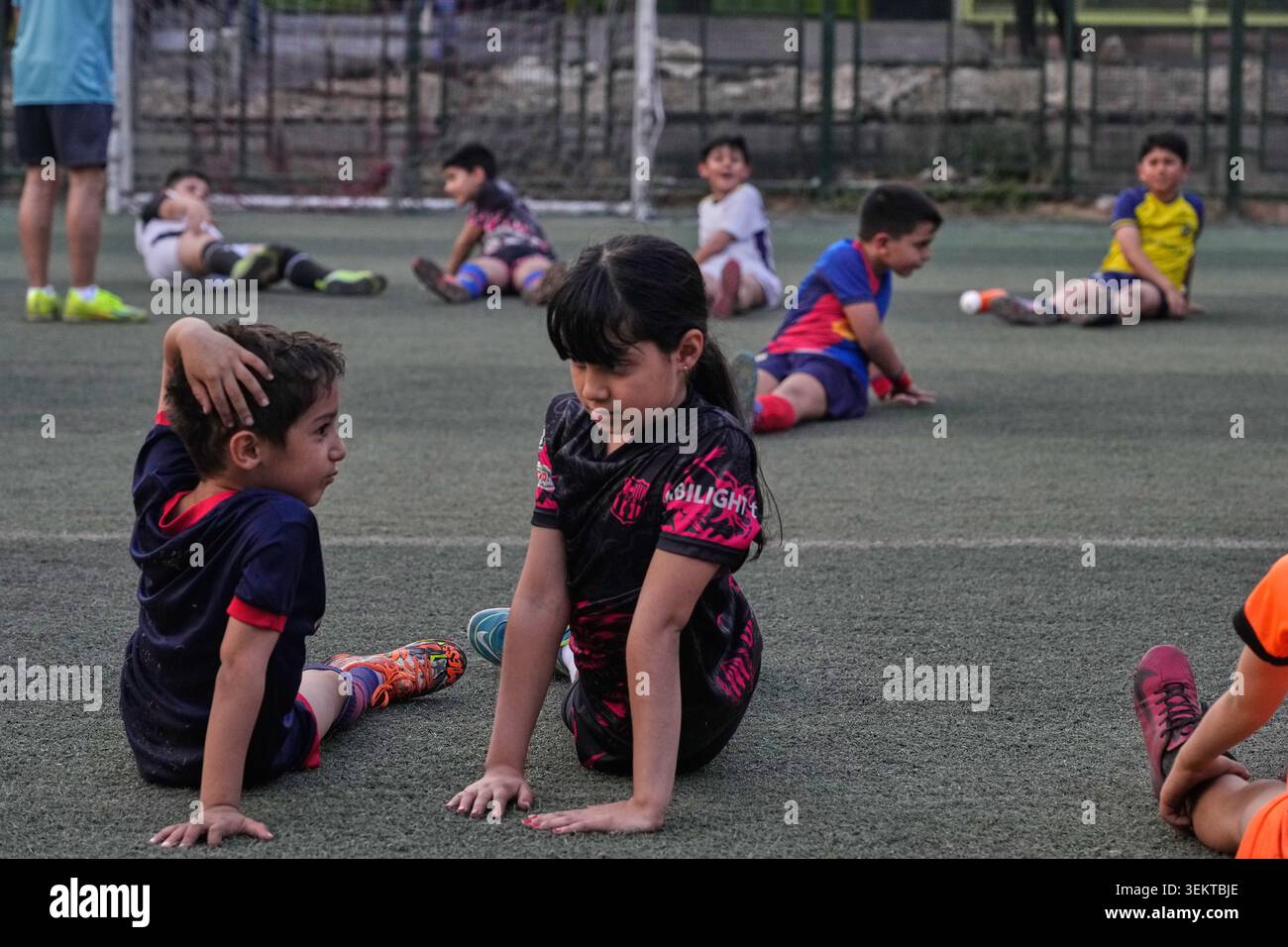 Children cool down at the conclusion of a training session in a soccer ...