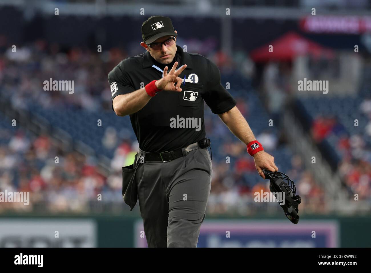 Umpire Alex MacKay gestures during a baseball game between the ...