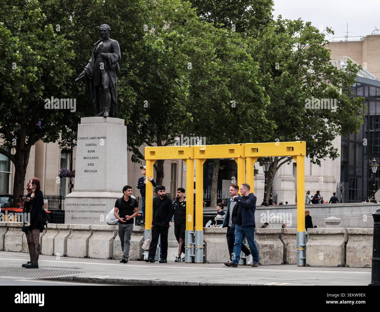 People seen walking through metal and concrete gates that protect ...