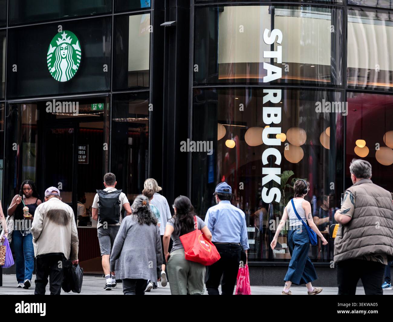 Starbucks logo is seen as people walk in front of the shop on landmark ...