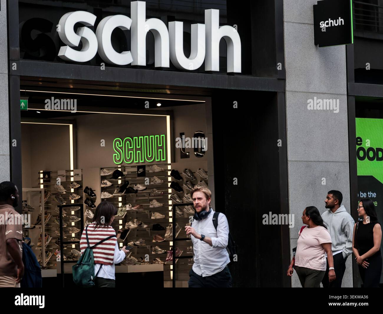 Schuh logo is seen as people walk in front of the shop on landmark ...