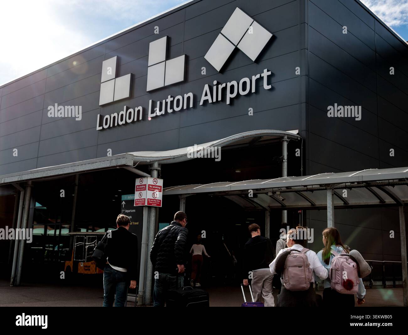 Passengers seen entering in a building with London Luton Airport logo ...