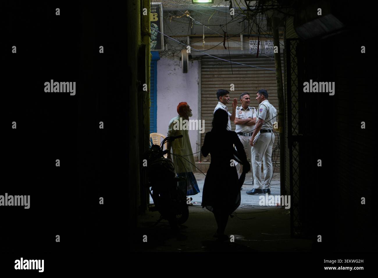 An elderly man looks on as policemen guard next to a restaurant and ...