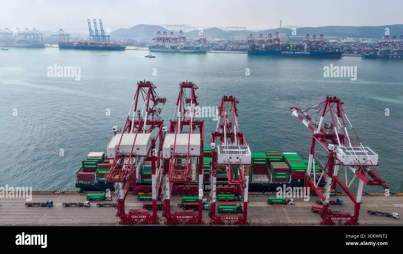 Workers handle cargo at Qingdao Port in east China's Shandong Province ...