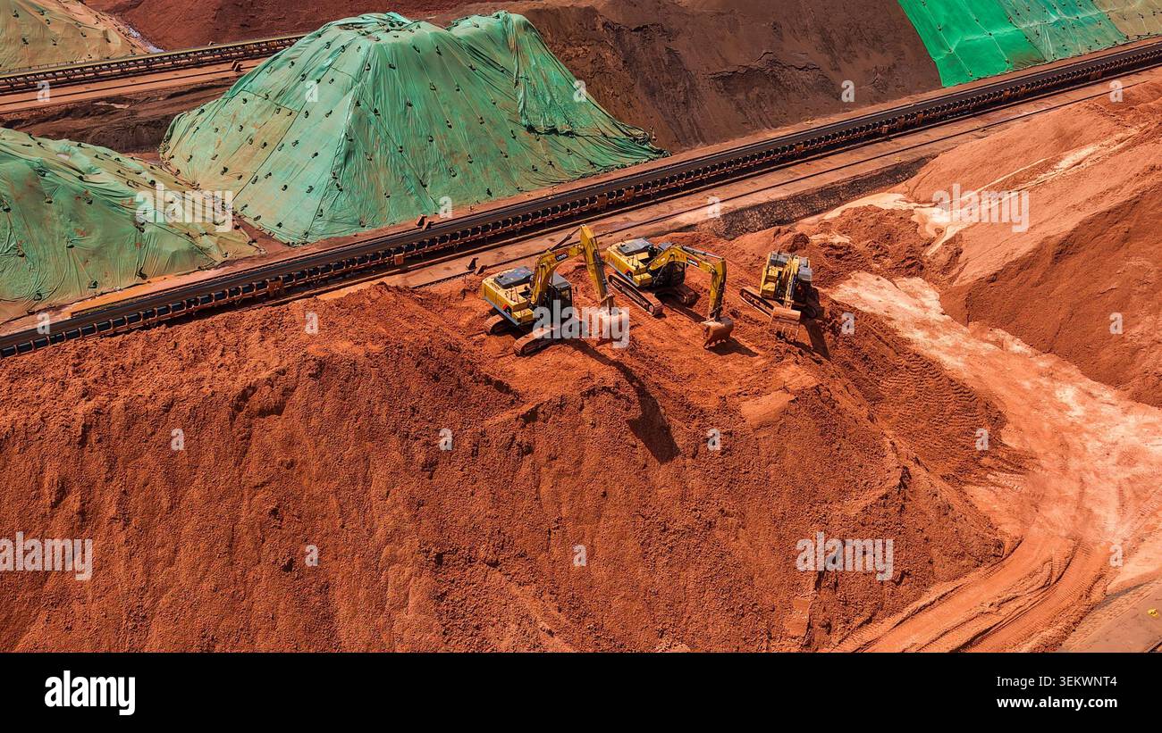 Engineering vehicles operate at the iron ore terminal of Qingdao Port ...