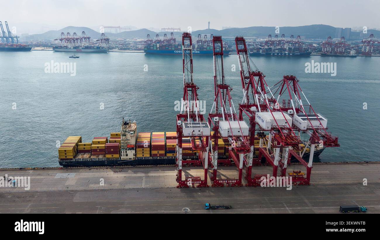Workers handle cargo at Qingdao Port in east China's Shandong Province ...