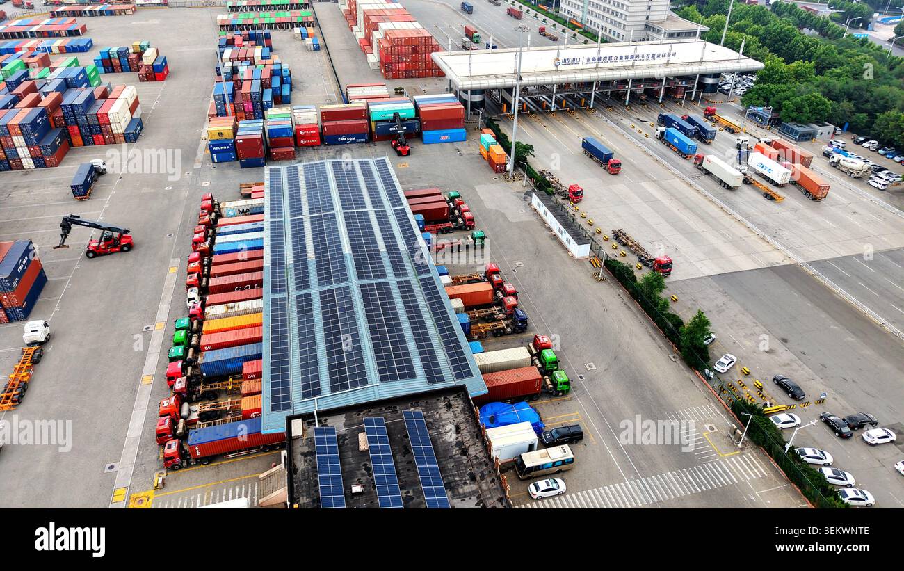 A cargo ship loaded with foreign trade containers docks at Qingdao Port ...