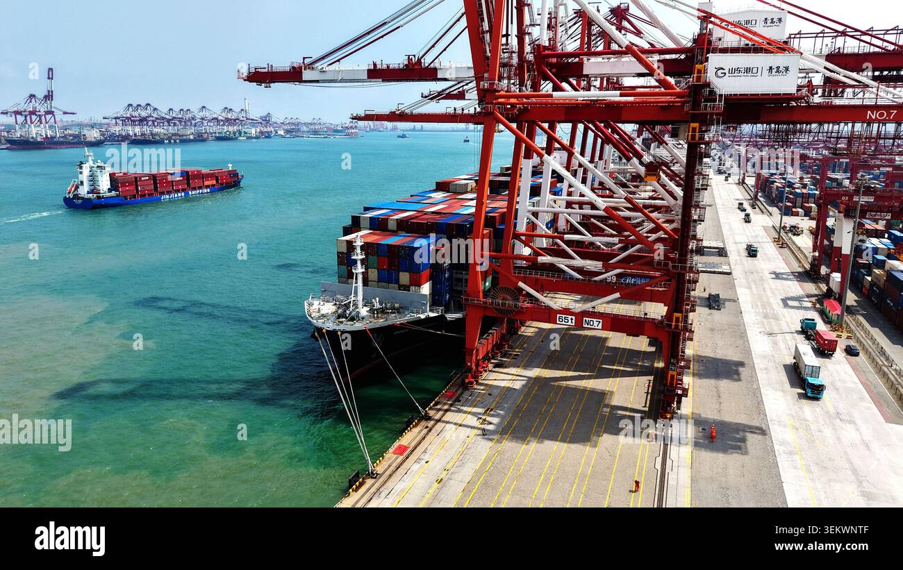 A cargo ship loaded with foreign trade containers docks at Qingdao Port ...