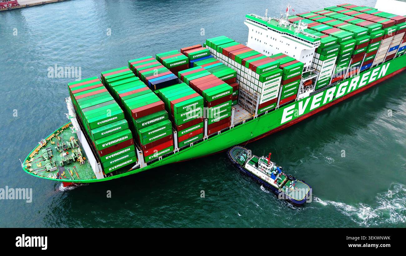 A cargo ship loaded with foreign trade containers docks at Qingdao Port ...