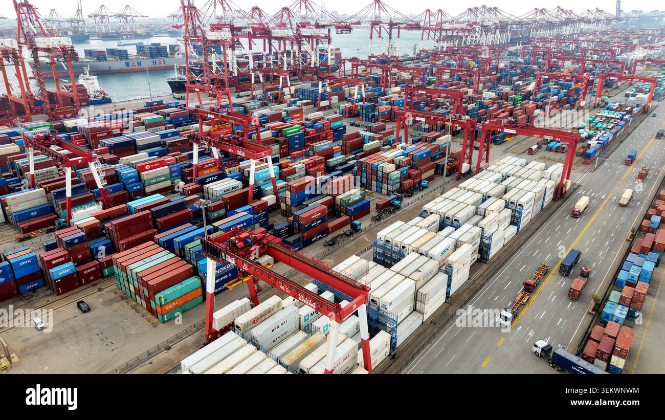 A cargo ship loaded with foreign trade containers docks at Qingdao Port ...
