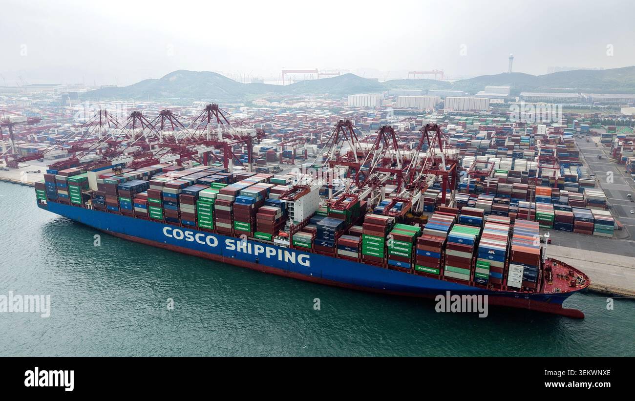 A cargo ship loaded with foreign trade containers docks at Qingdao Port ...