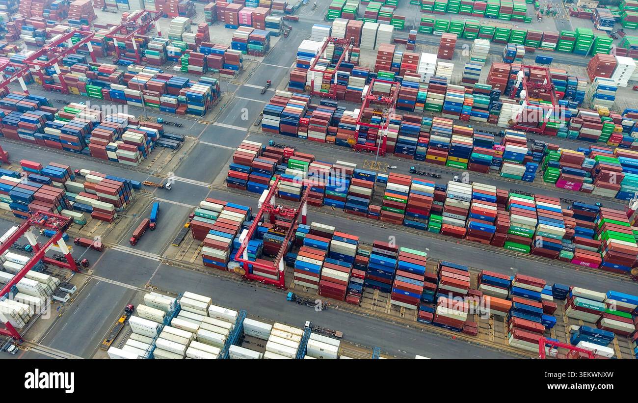 Workers handle cargo at Qingdao Port in east China's Shandong Province ...