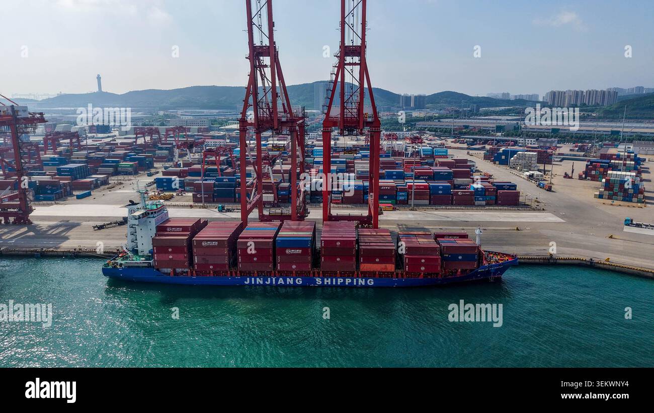 Workers handle cargo at Qingdao Port in east China's Shandong Province ...