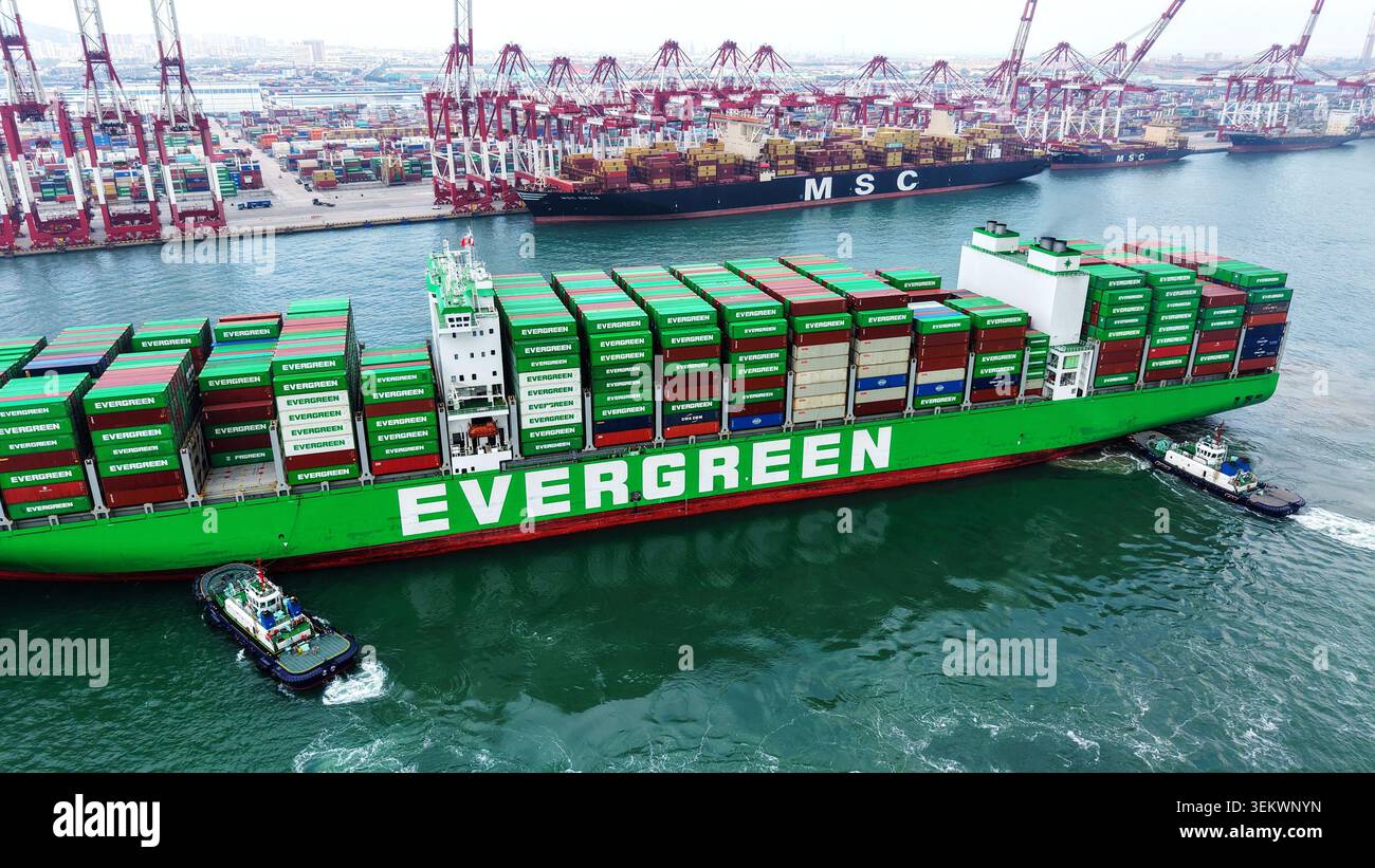 A cargo ship loaded with foreign trade containers docks at Qingdao Port ...