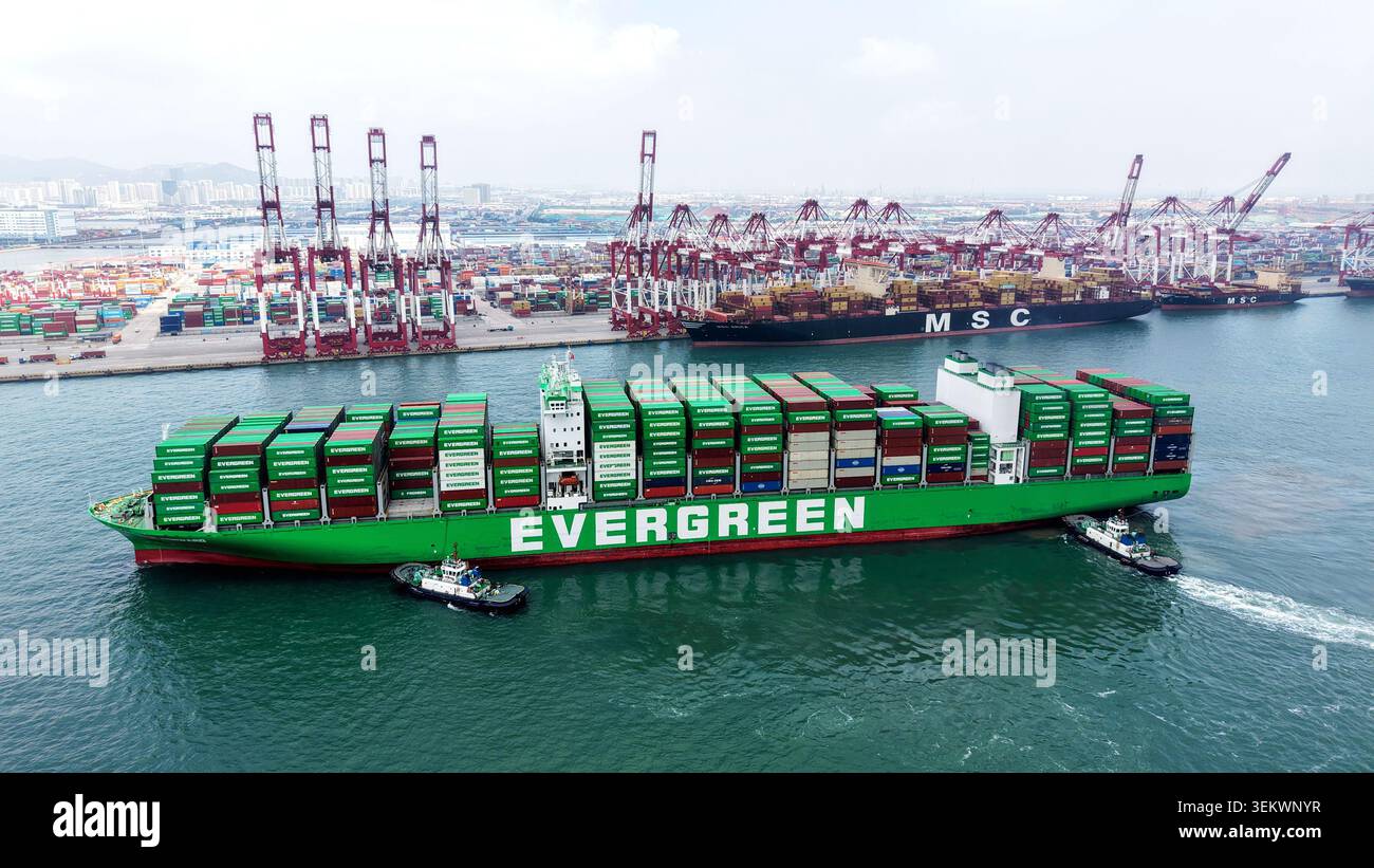 A cargo ship loaded with foreign trade containers docks at Qingdao Port ...