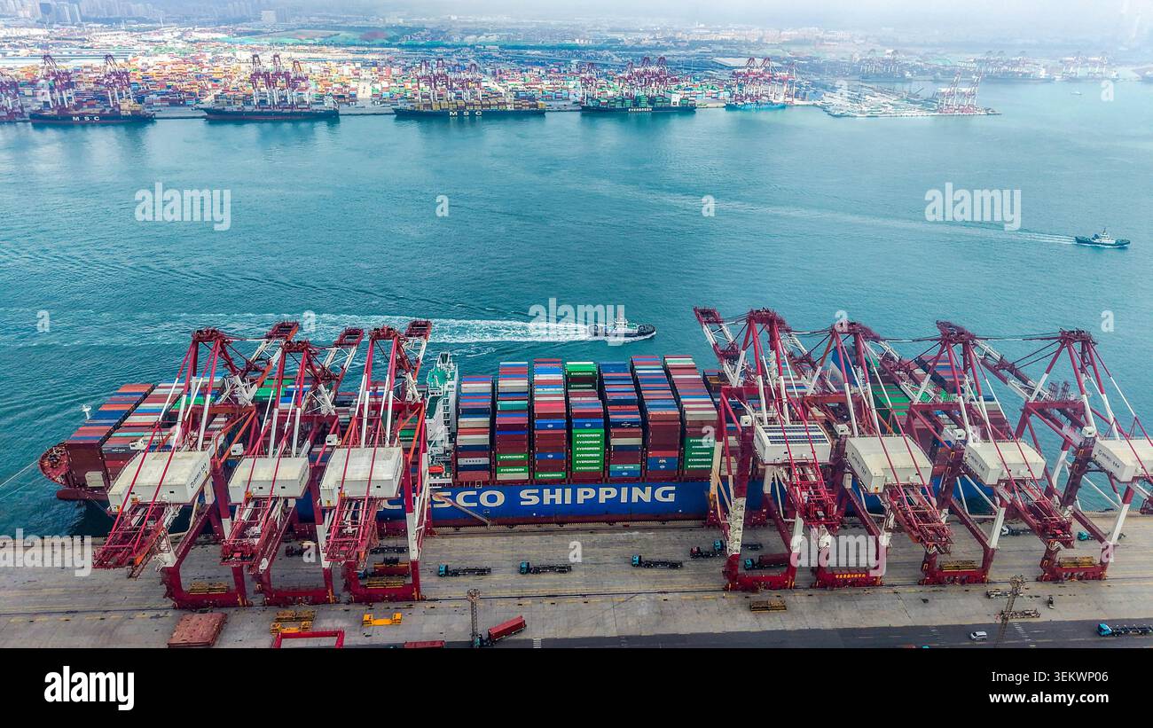 Workers handle cargo at Qingdao Port in east China's Shandong Province ...