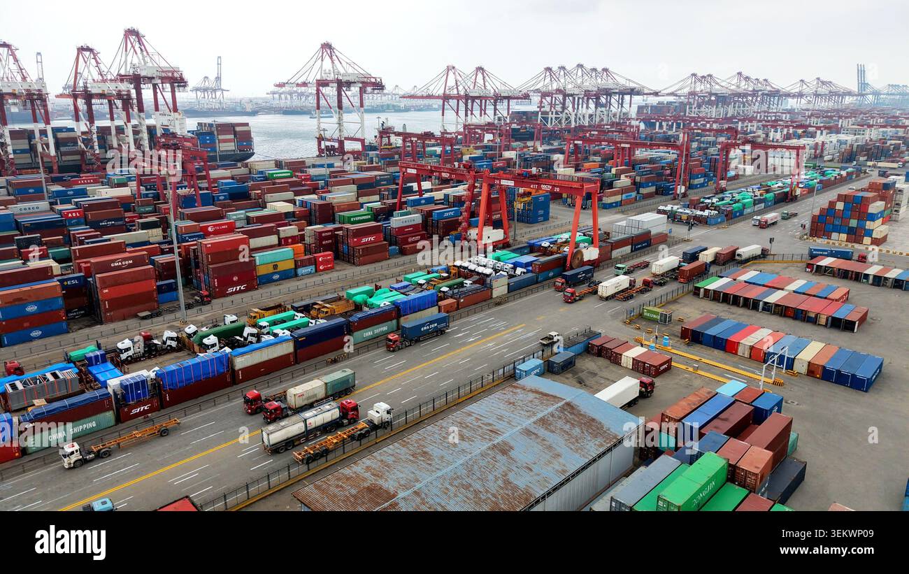 A cargo ship loaded with foreign trade containers docks at Qingdao Port ...
