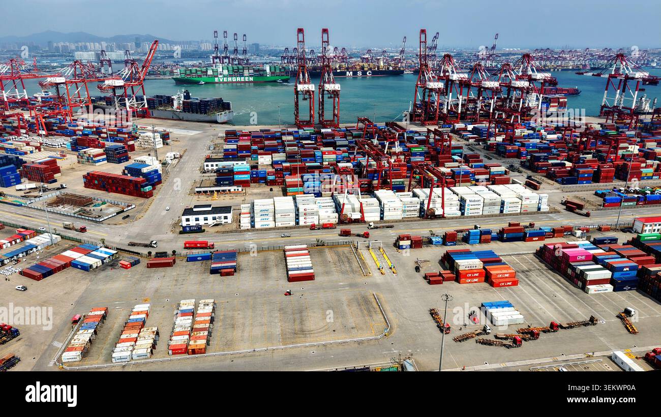 A cargo ship loaded with foreign trade containers docks at Qingdao Port ...