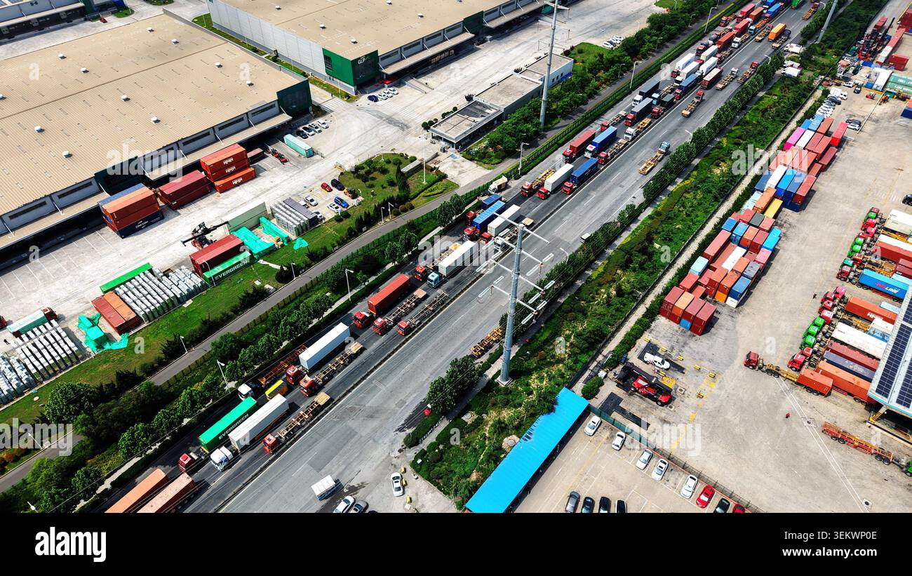 A cargo ship loaded with foreign trade containers docks at Qingdao Port ...