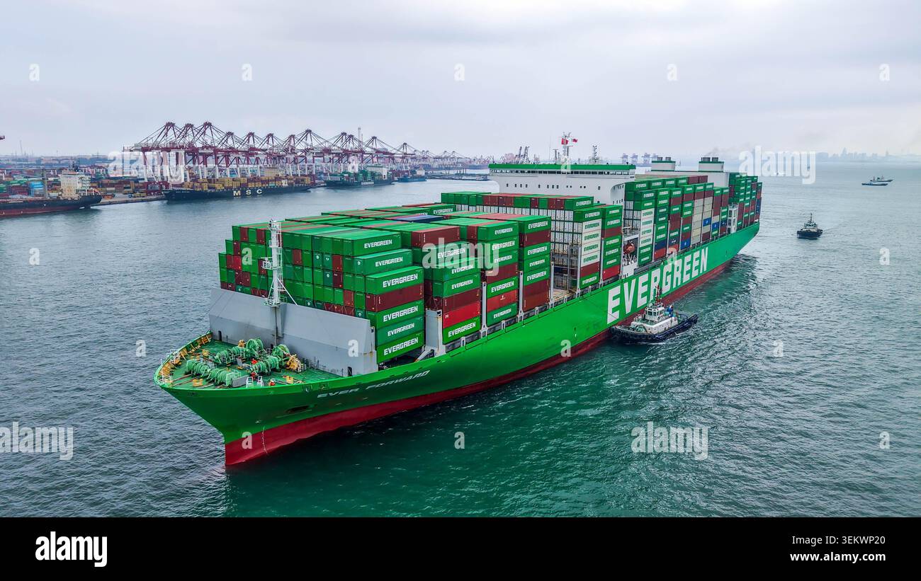 Workers handle cargo at Qingdao Port in east China's Shandong Province ...