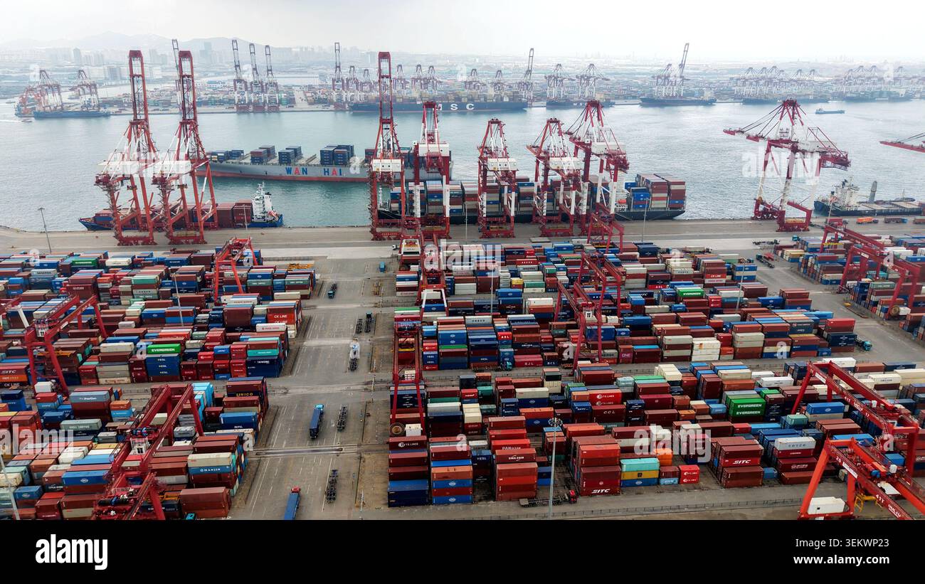 A cargo ship loaded with foreign trade containers docks at Qingdao Port ...