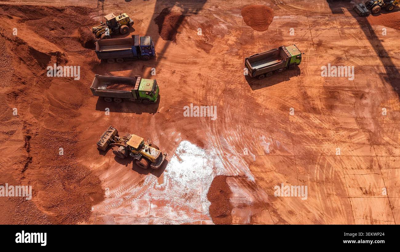Engineering vehicles operate at the iron ore terminal of Qingdao Port ...