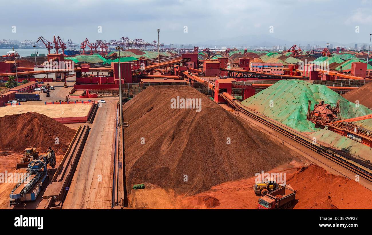 Engineering vehicles operate at the iron ore terminal of Qingdao Port ...