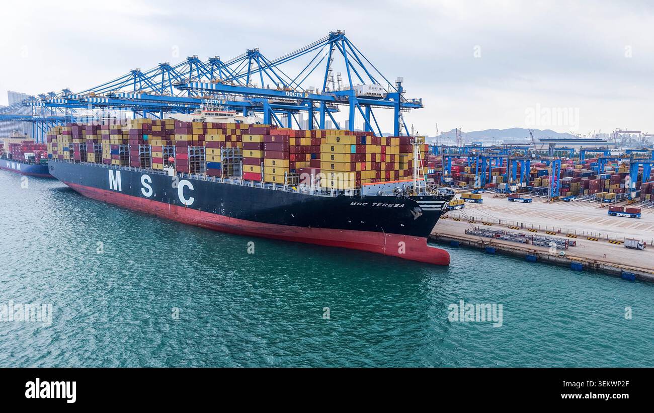 Workers handle cargo at Qingdao Port in east China's Shandong Province ...