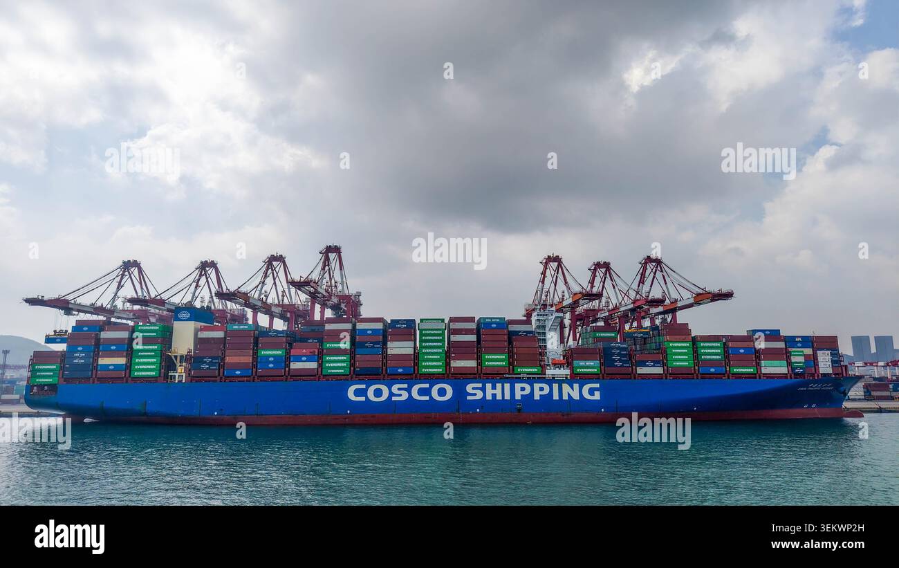 Workers handle cargo at Qingdao Port in east China's Shandong Province ...