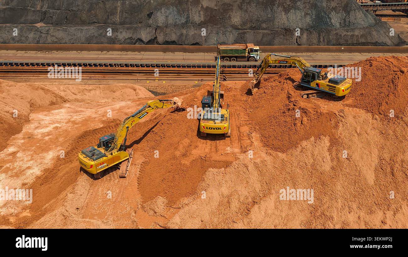 Engineering vehicles operate at the iron ore terminal of Qingdao Port ...