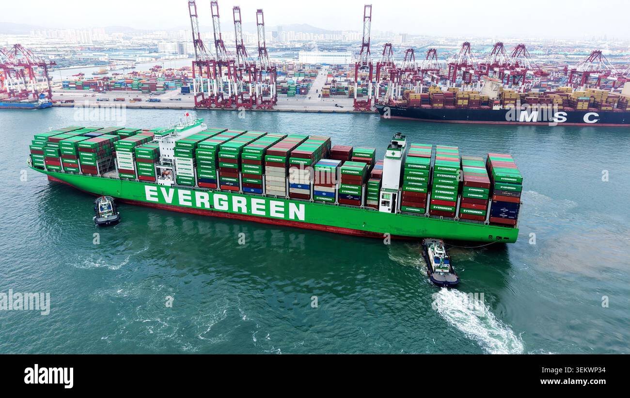 A cargo ship loaded with foreign trade containers docks at Qingdao Port ...