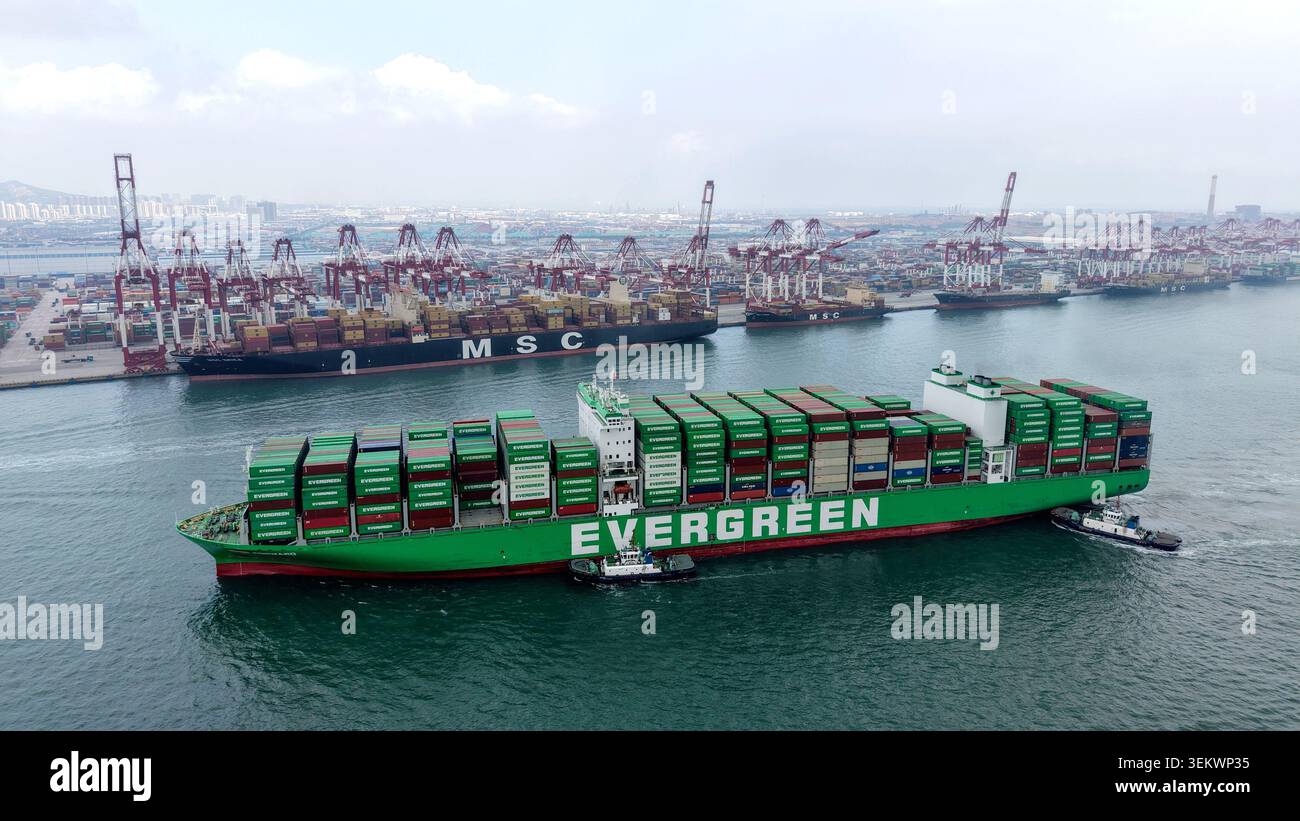 A cargo ship loaded with foreign trade containers docks at Qingdao Port ...