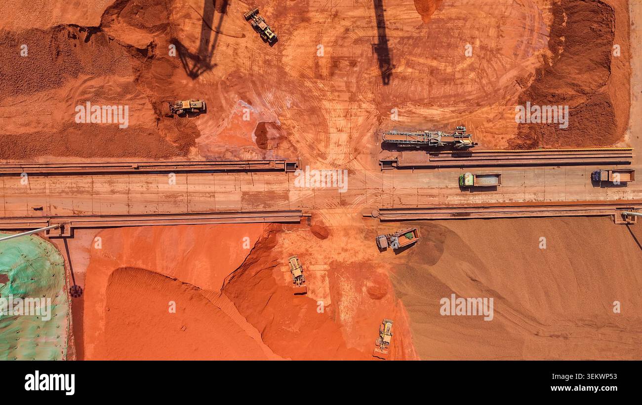 Engineering vehicles operate at the iron ore terminal of Qingdao Port ...