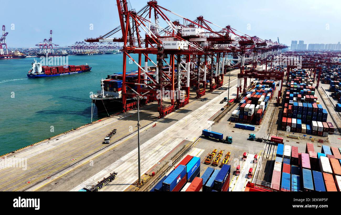 A cargo ship loaded with foreign trade containers docks at Qingdao Port ...
