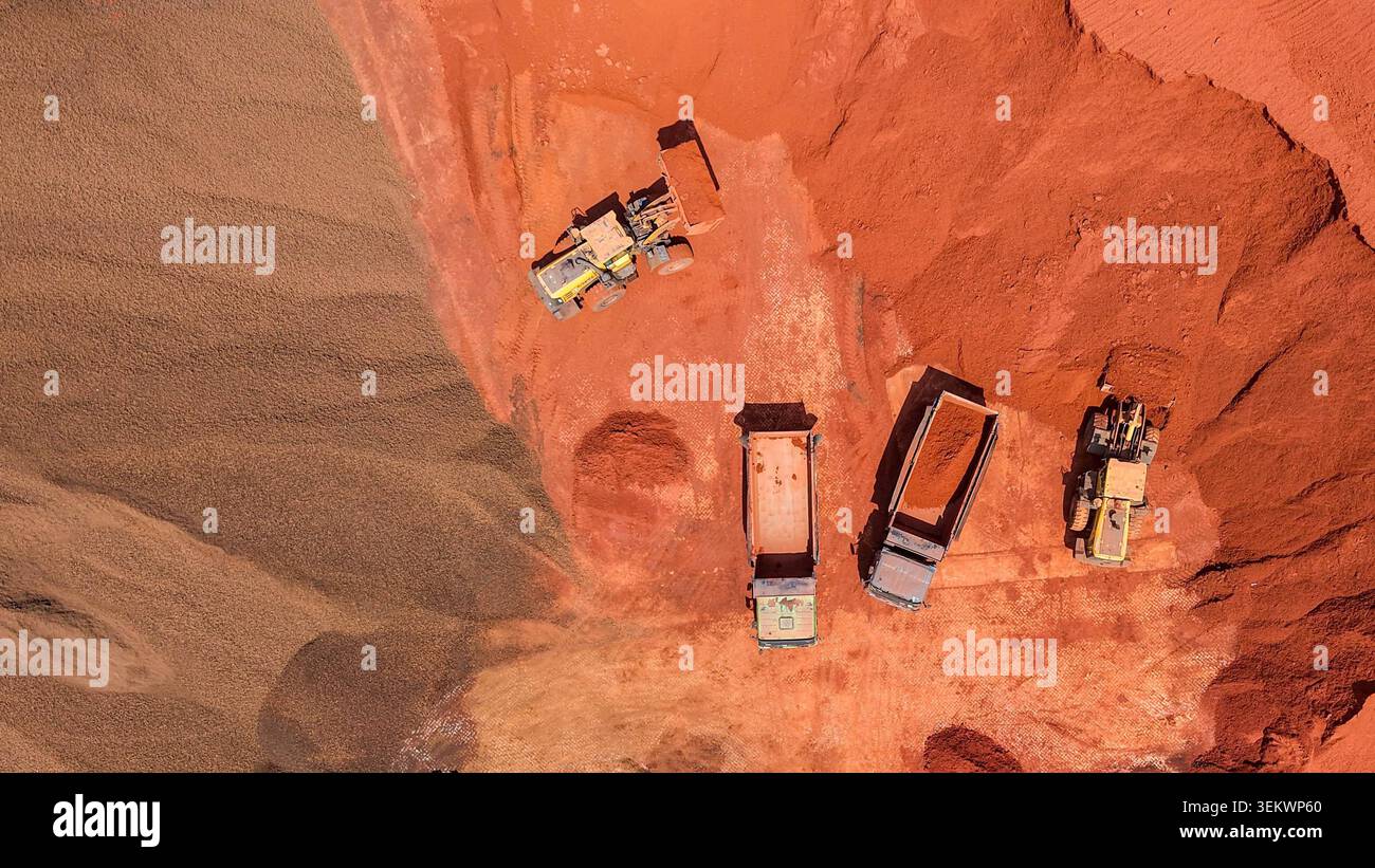 Engineering vehicles operate at the iron ore terminal of Qingdao Port ...