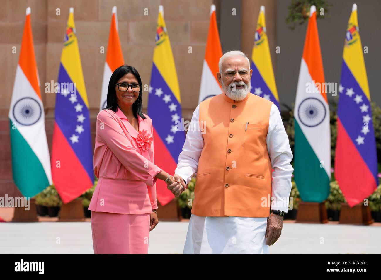 Venezuela's acting President Delcy Rodriguez, left, shakes hands with ...