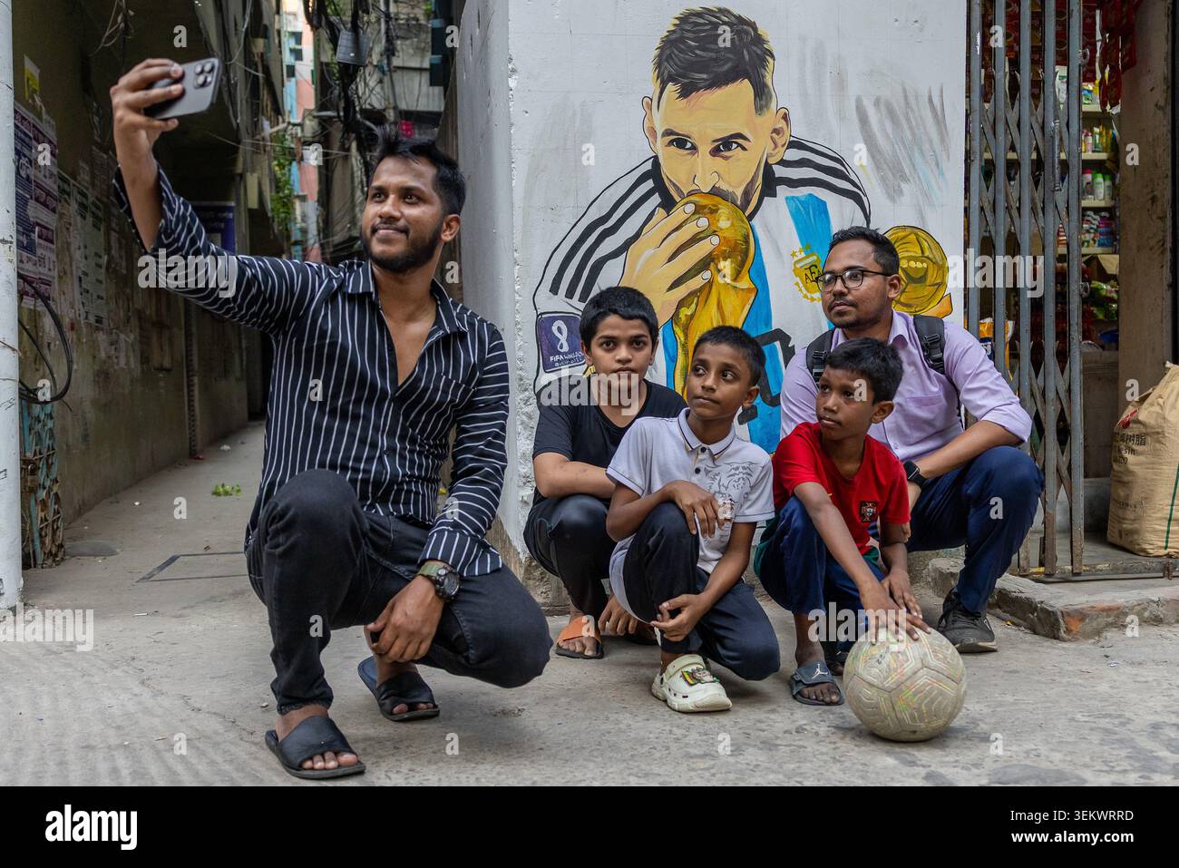 Fans seen taking a selfie with a graffiti of famous football star ...