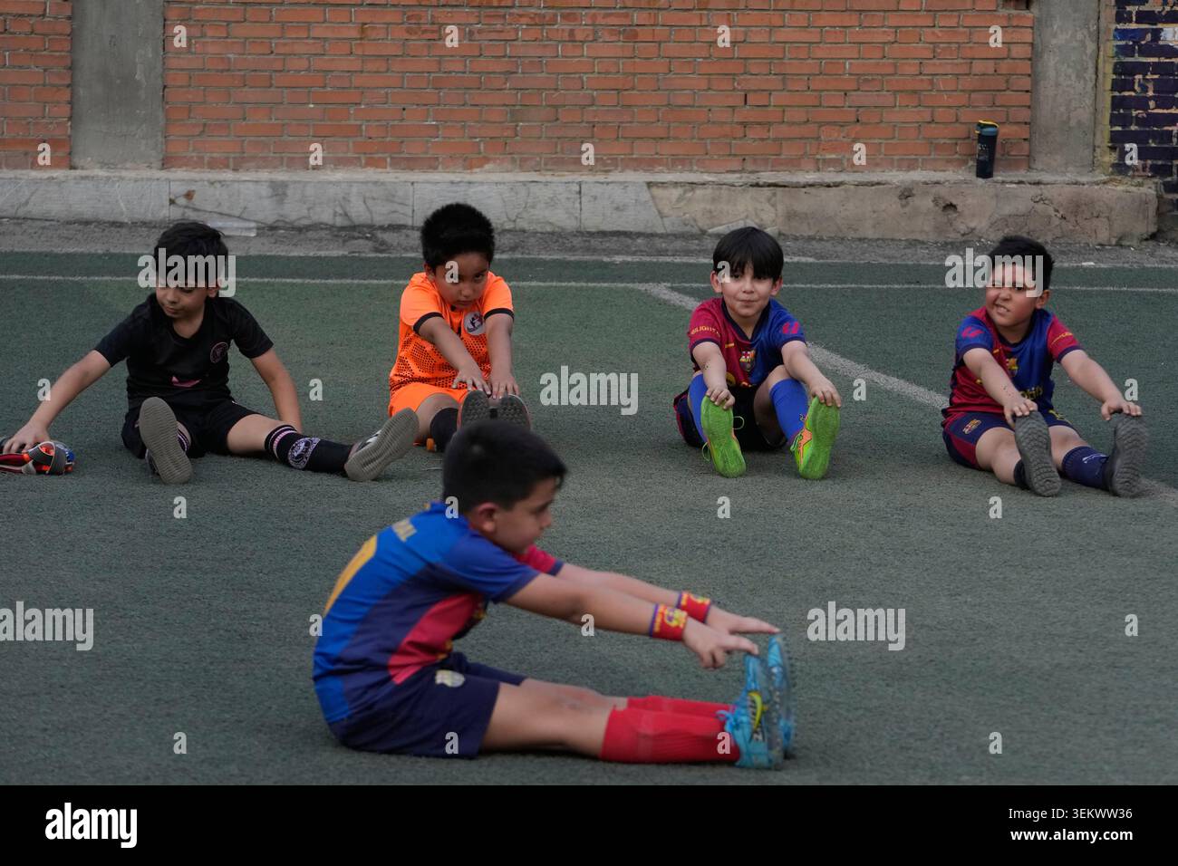 Children cool down at the conclusion of a training session in a soccer ...
