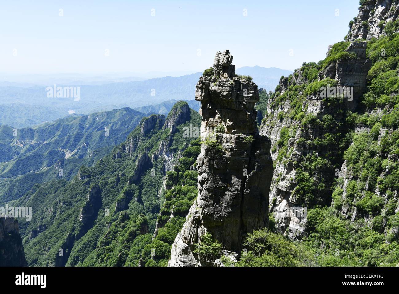 Tourists visit the snow-covered rocks at Baiyun Mountain Scenic Area in ...