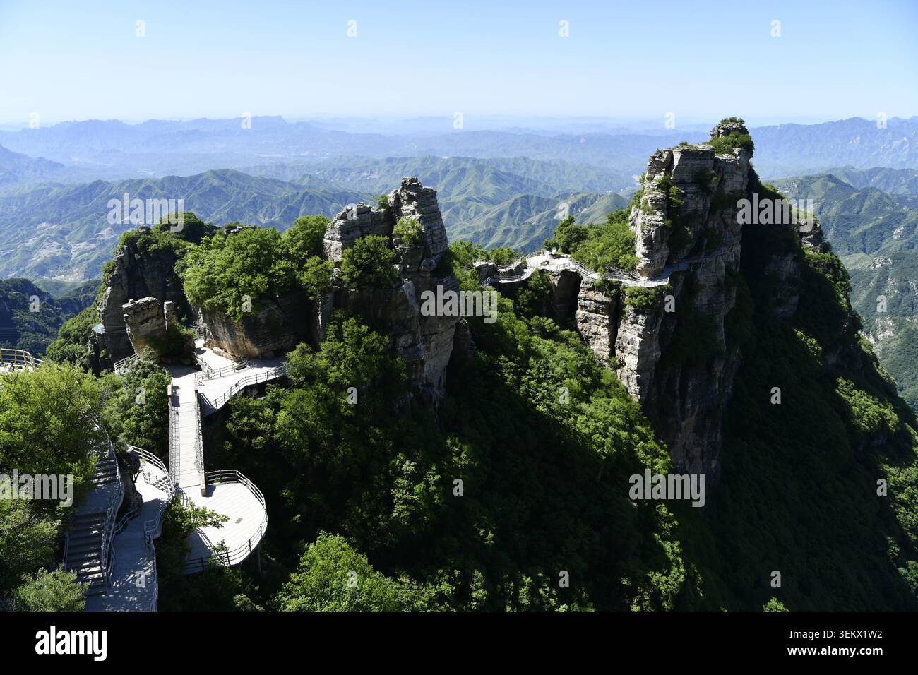 Tourists visit the snow-covered rocks at Baiyun Mountain Scenic Area in ...