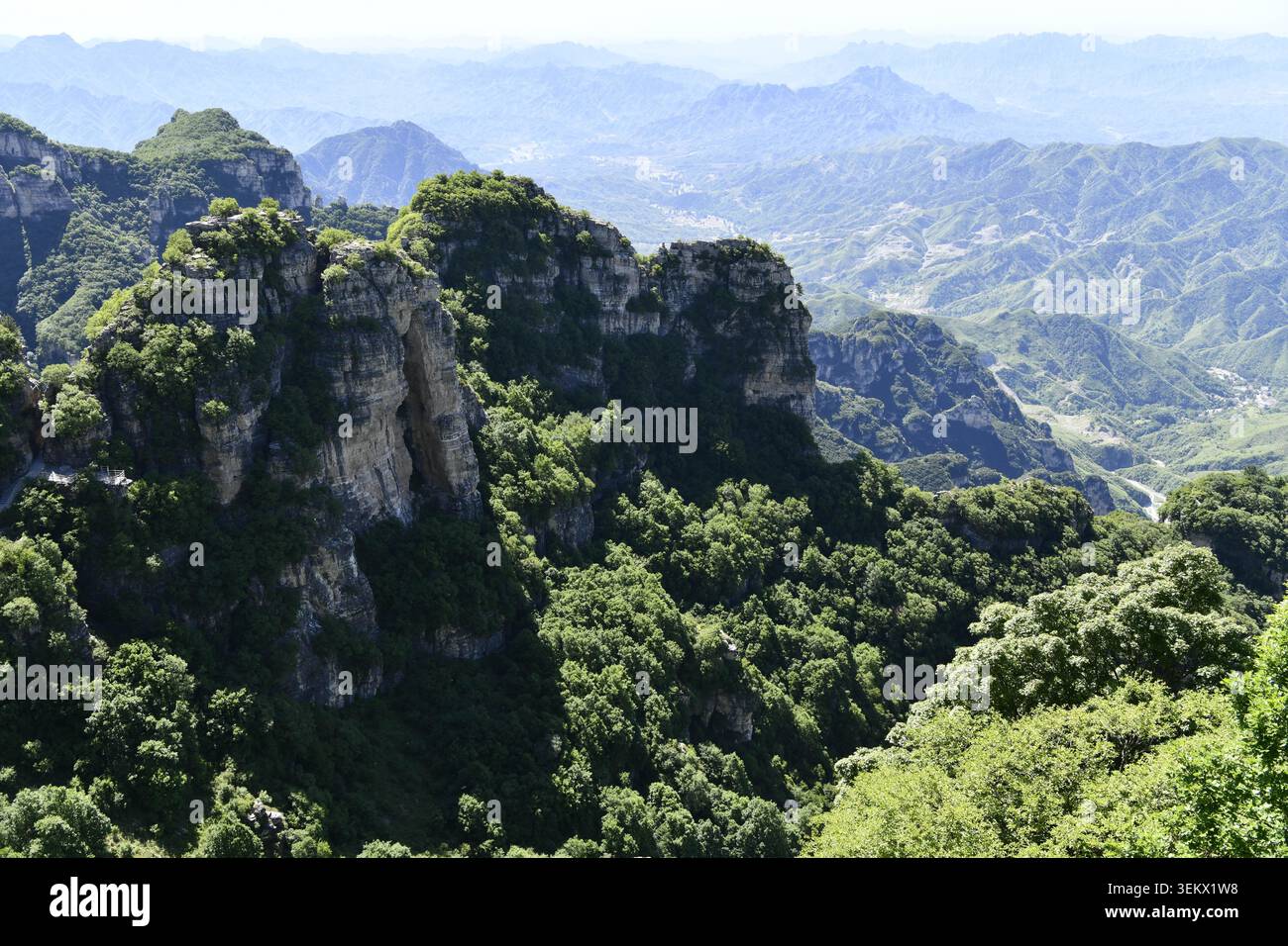 Tourists visit the snow-covered rocks at Baiyun Mountain Scenic Area in ...