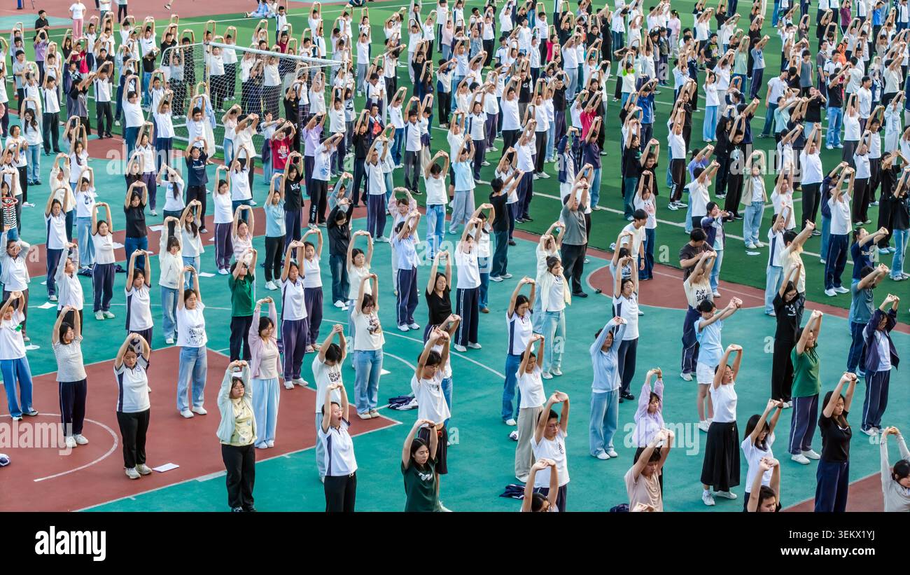 Over 1,900 senior high school students practice yoga under professional ...