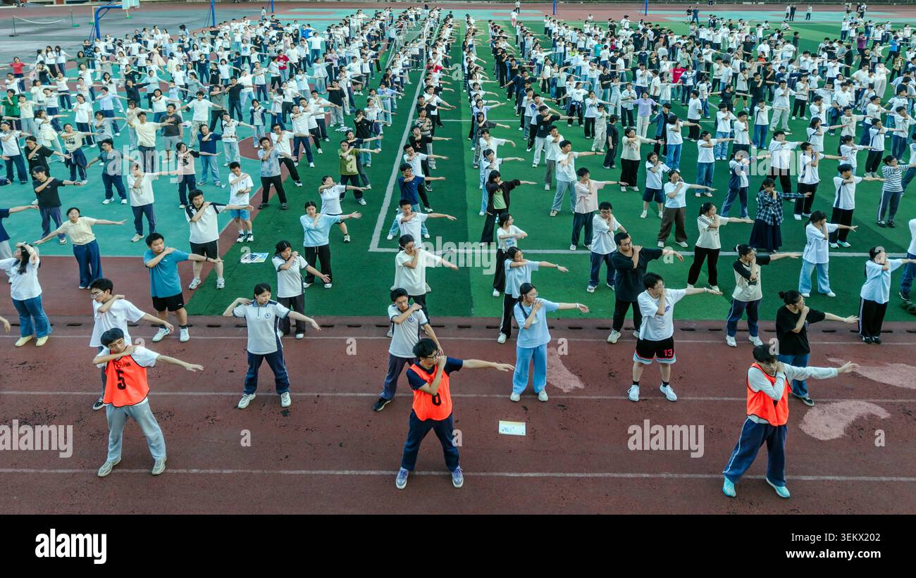 Over 1,900 senior high school students practice yoga under professional ...
