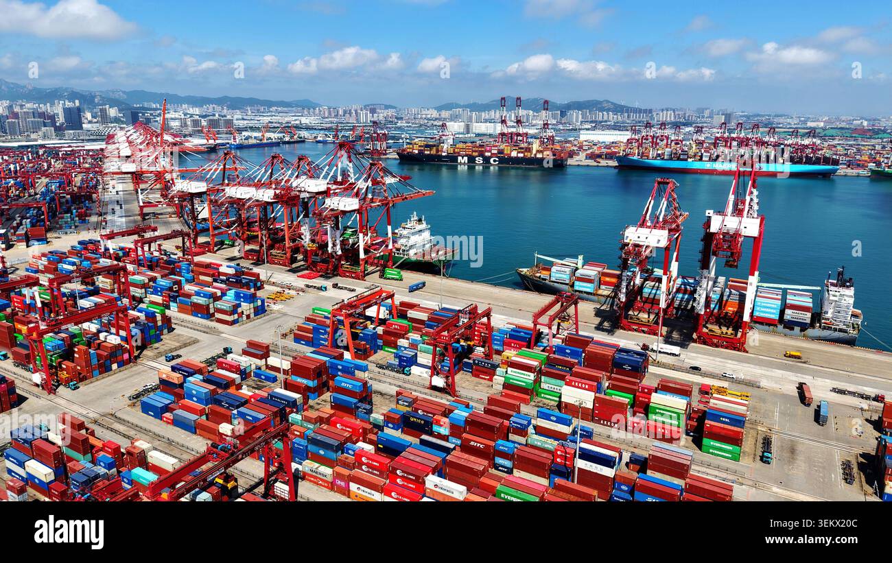 Workers transport foreign trade containers at Qingdao Port in east ...