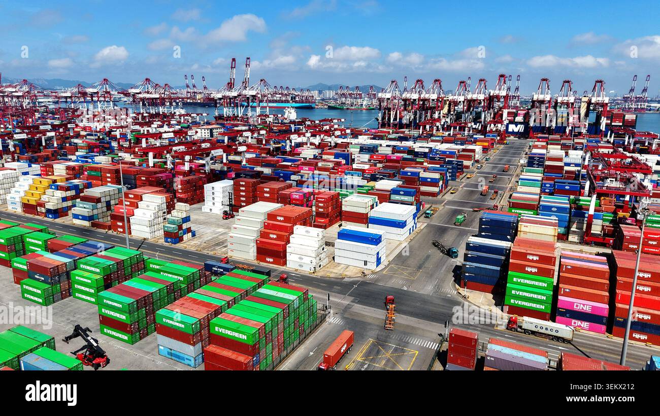Workers transport foreign trade containers at Qingdao Port in east ...