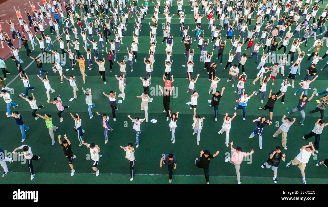 Over 1,900 senior high school students practice yoga under professional ...