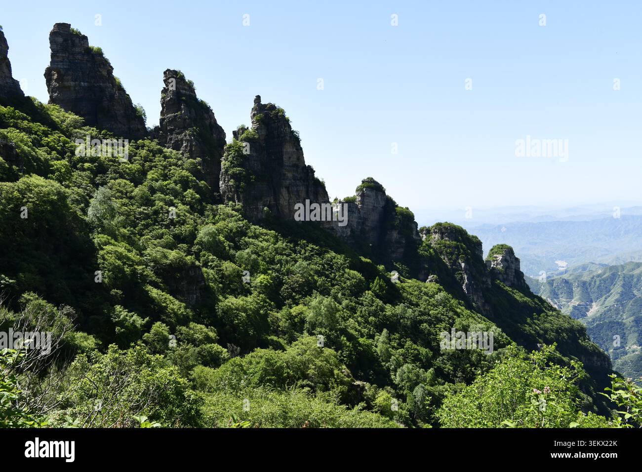 Tourists visit the snow-covered rocks at Baiyun Mountain Scenic Area in ...